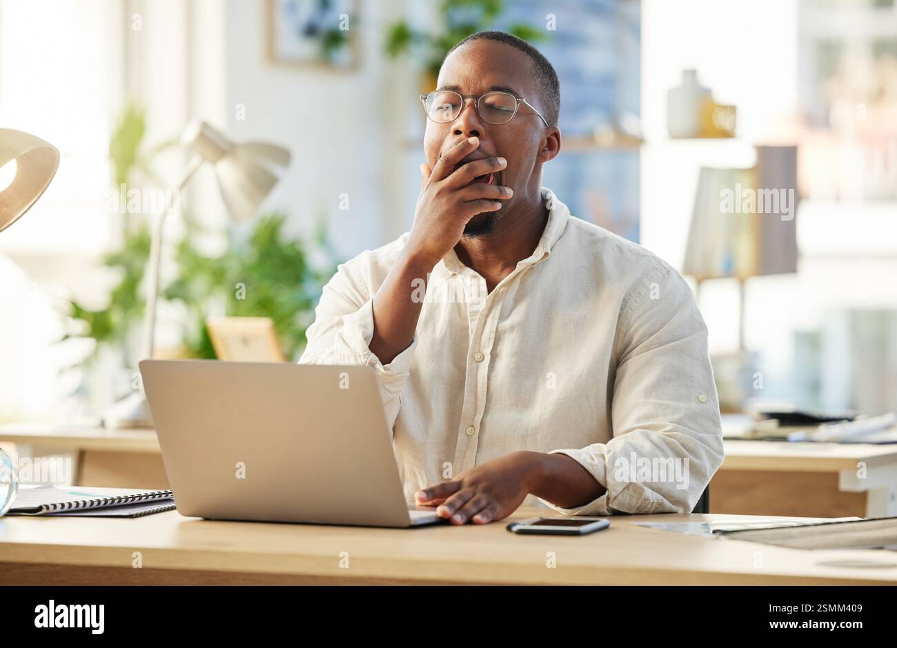 Black man, laptop and tired yawn in office, employee and brain fog ...