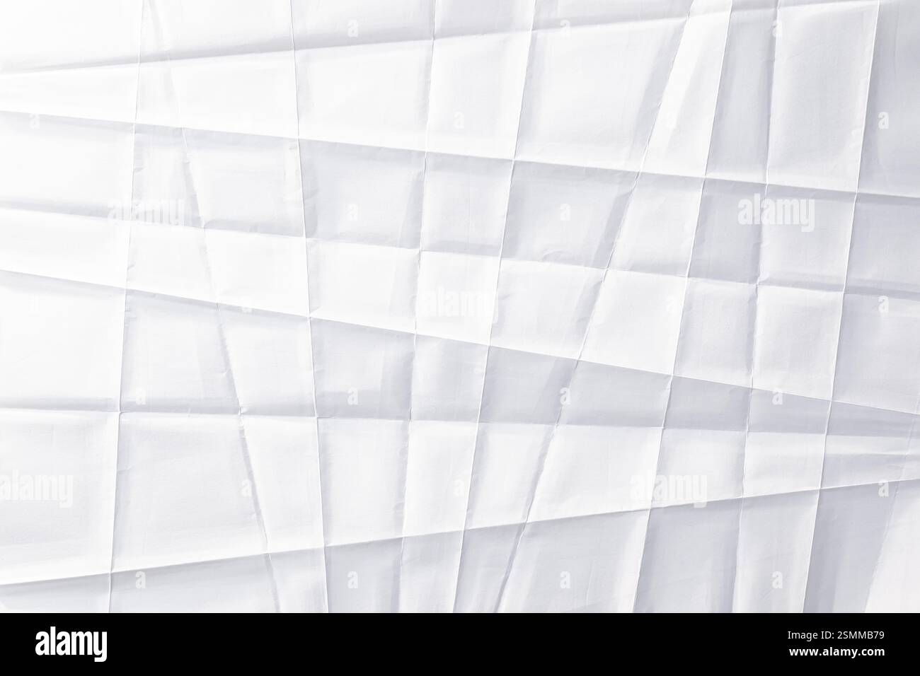 Close-up view of textured white paper displaying various folds and ...