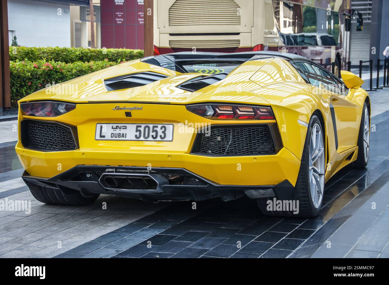 A gleaming yellow Lamborghini Aventador, Dubai license plate glinting ...