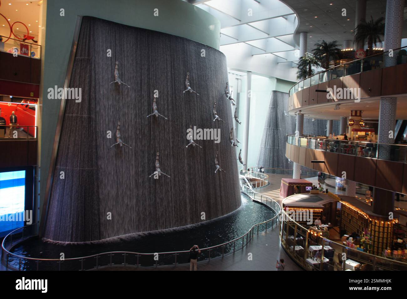 A magnificent indoor waterfall cascades down through the Dubai Mall ...