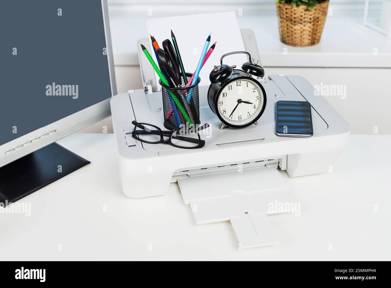 Workstation setup featuring a printer, decorative items, and ...