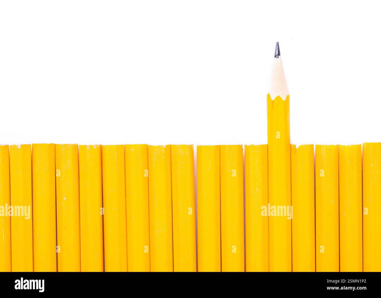 Unique arrangement of yellow pencils with one sharpened pencil standing ...
