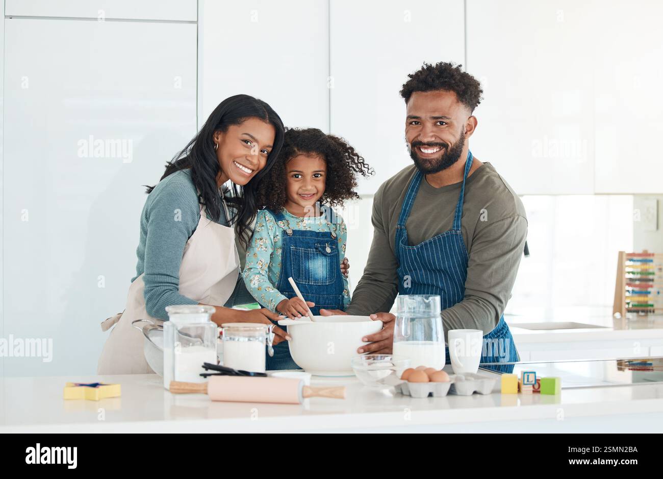 Parents, daughter and baking portrait in kitchen with bonding together ...