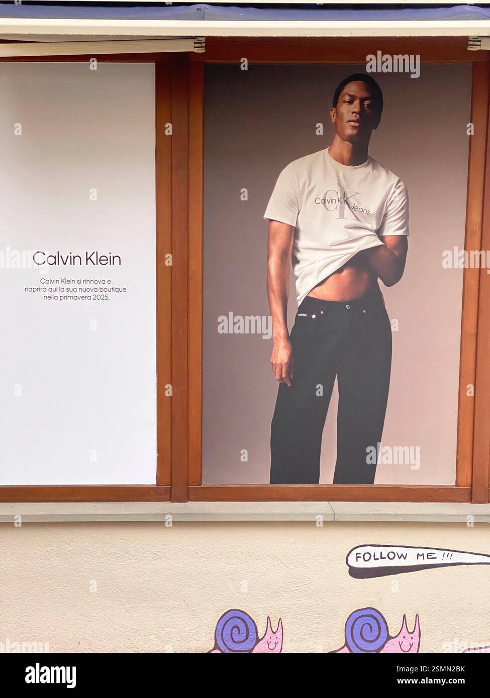 Large Calvin Klein advertisement displayed on a shop window at Fidenza ...