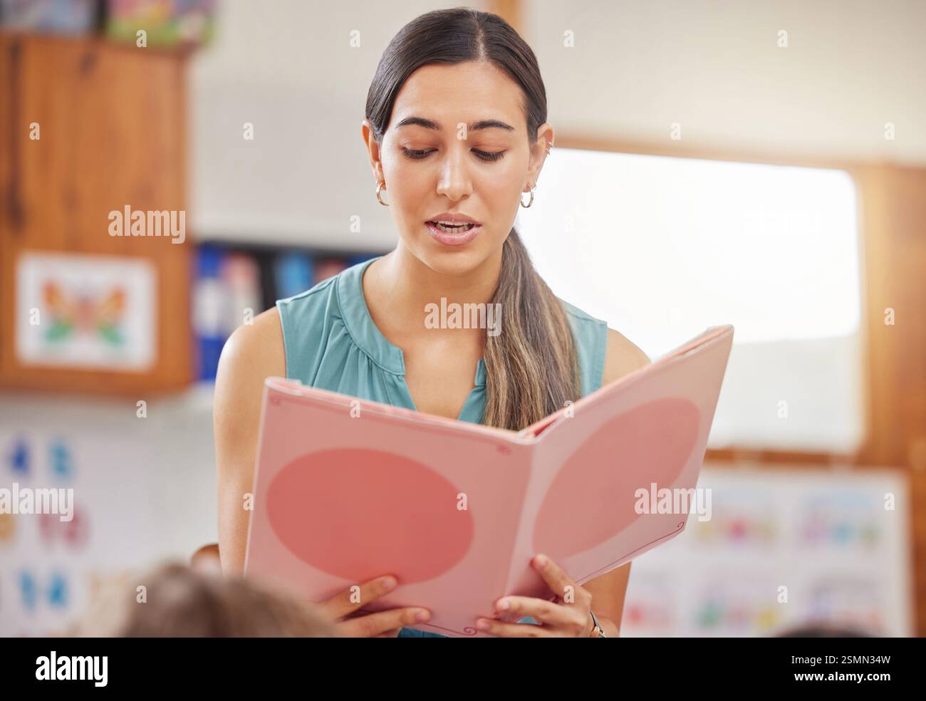 Class, woman teacher and reading to children, kindergarten education ...