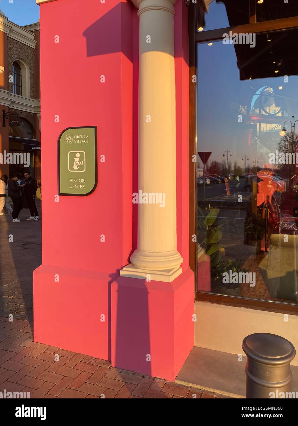 Pink wall with visitor center sign at Fidenza Village luxury outlet ...