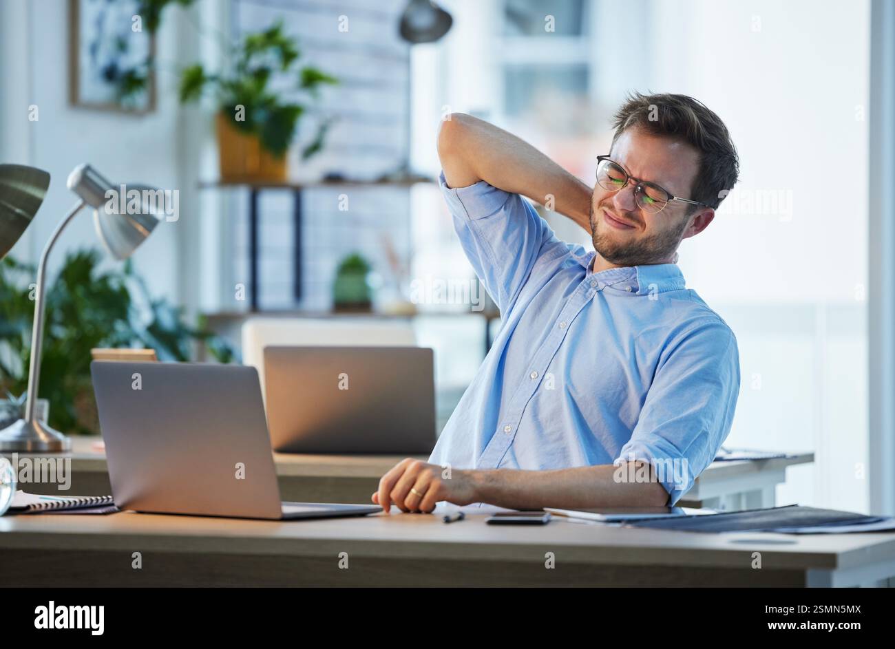 Frustrated, businessman and neck injury with pain on laptop for fatigue ...
