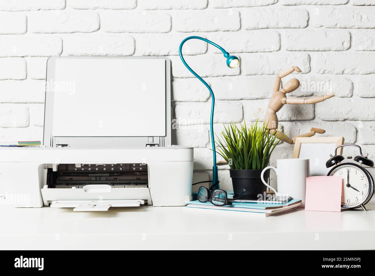 Workspace setup with printer, desk lamp, and decorative elements in a ...