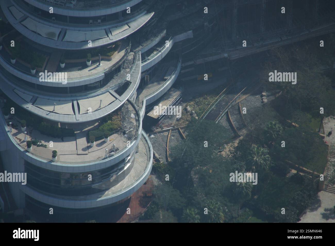 A helicopter or drone soars above Dubai, revealing a high-rise building ...