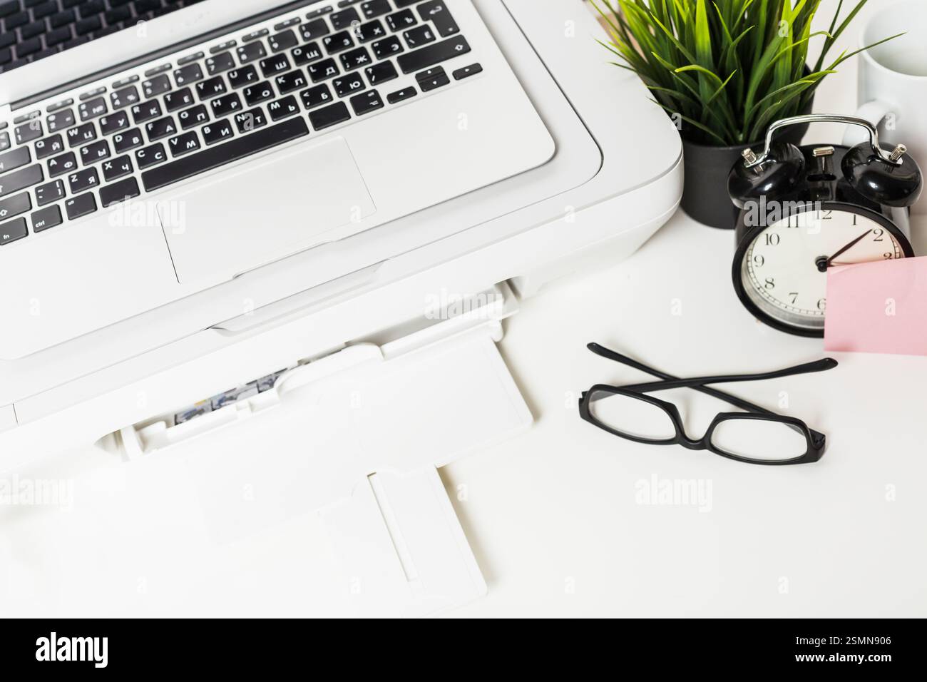 Workspace with laptop and printer displaying organized office ...
