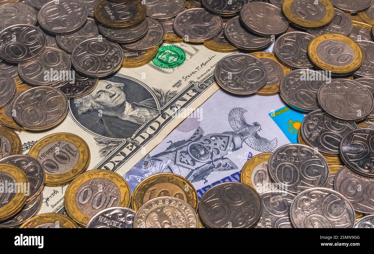 Dollar and tenge bills lie under the coins. Currency exchange ...