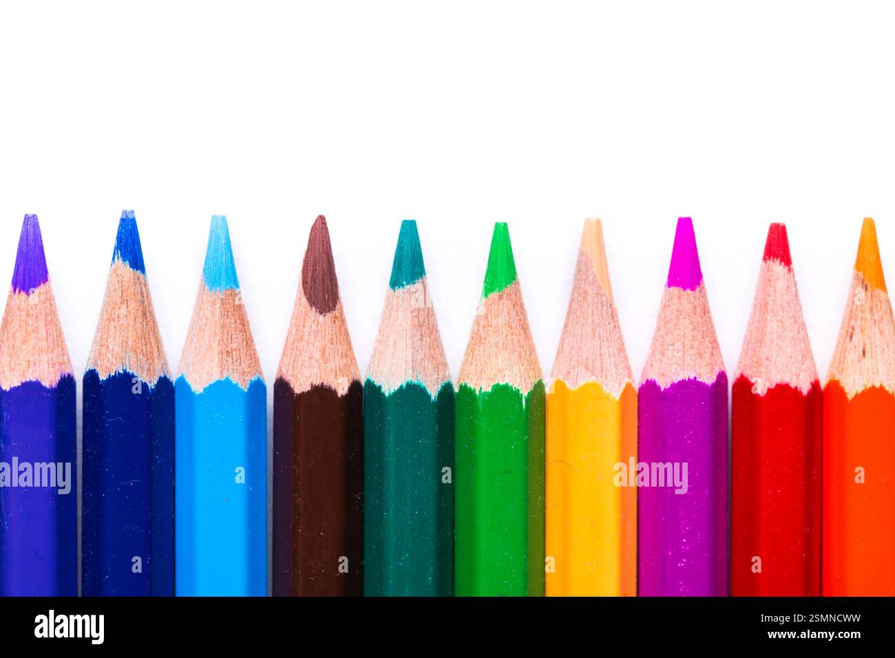 Vibrant assorted colored pencils arranged neatly on a white background ...