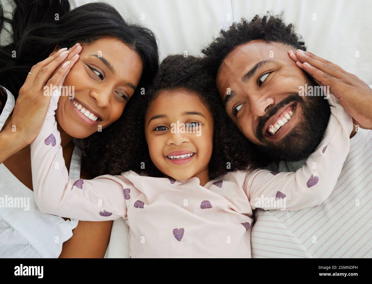 Family, hug and relax together in home, morning wake up and bonding ...