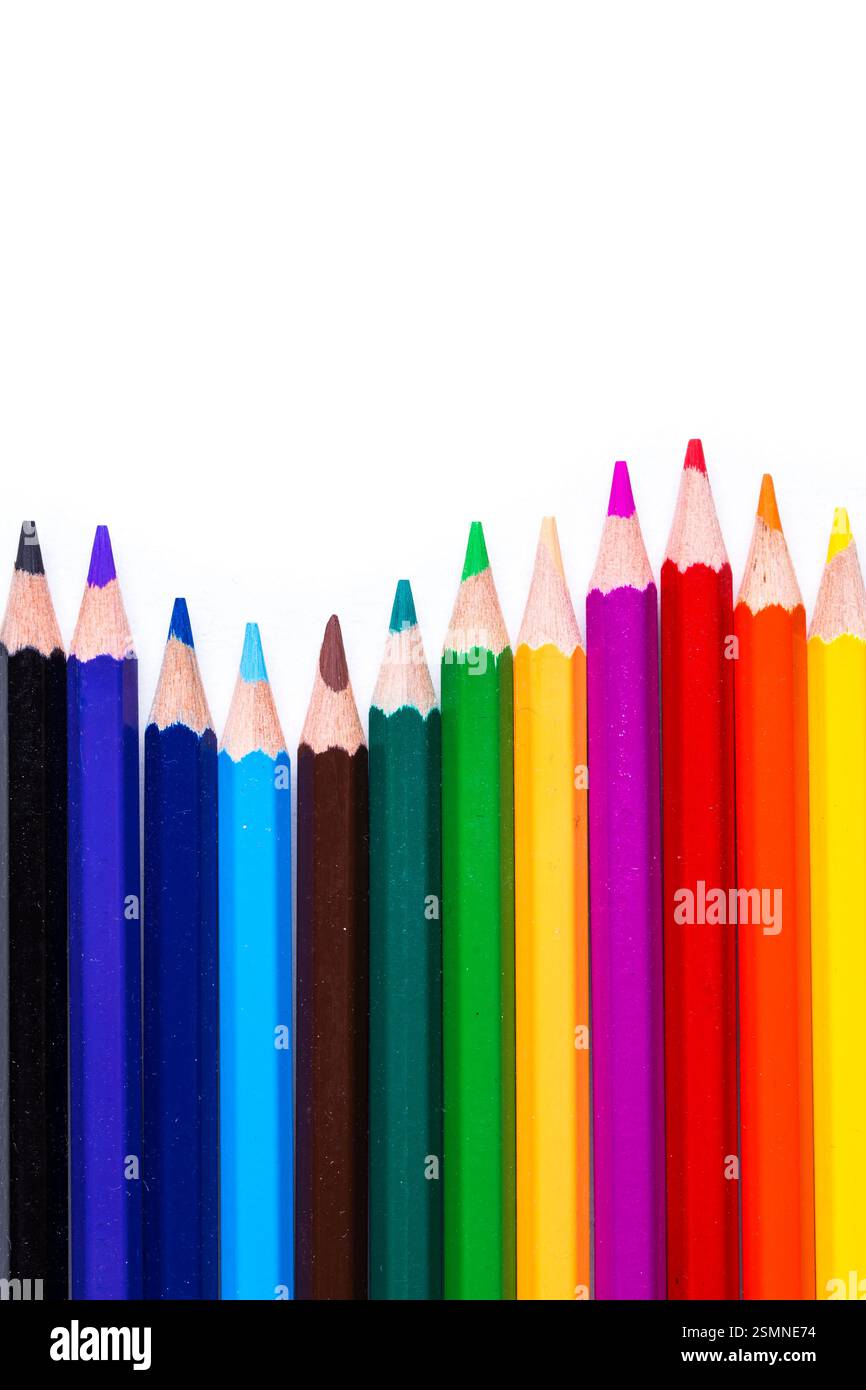 Colorful arrangement of pencil crayons on a white background ...