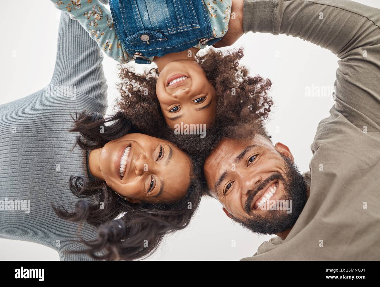 Low angle, parents and girl in portrait for hug, connection and bonding ...