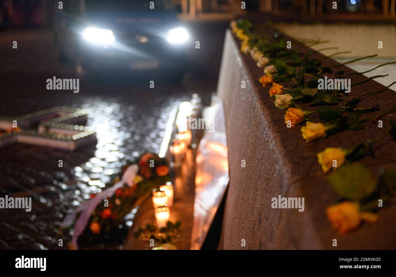 13 February 2025, Saxony, Dresden: Roses and candles are laid on the ...