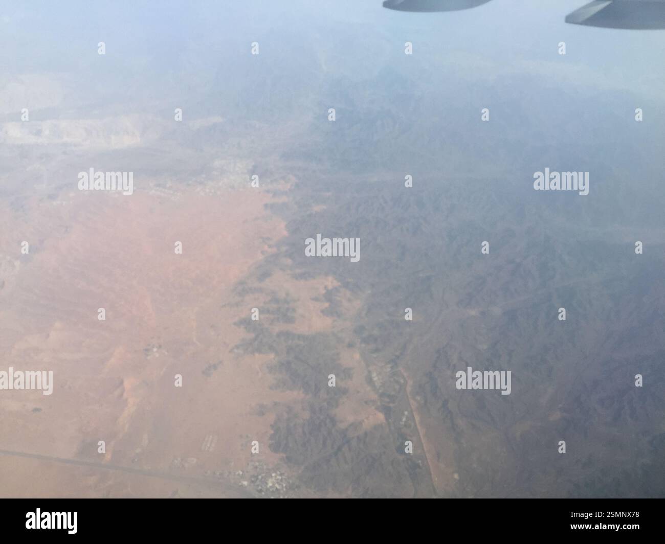 A breathtaking aerial view unfolds: snow-capped mountains pierce the ...