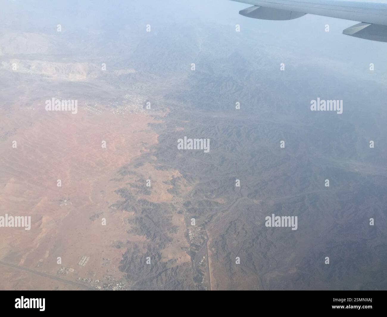 A breathtaking aerial view unfolds: snow-capped mountains pierce the ...