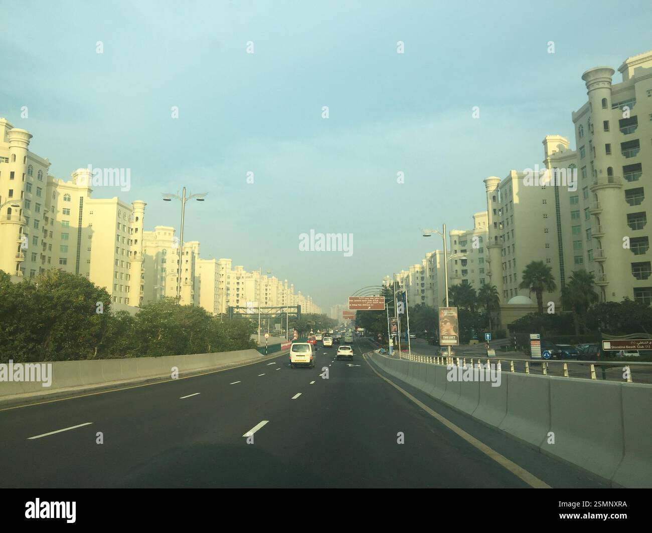 Palm Jumeirah highway cuts through a vibrant Dubai cityscape. Rows of ...
