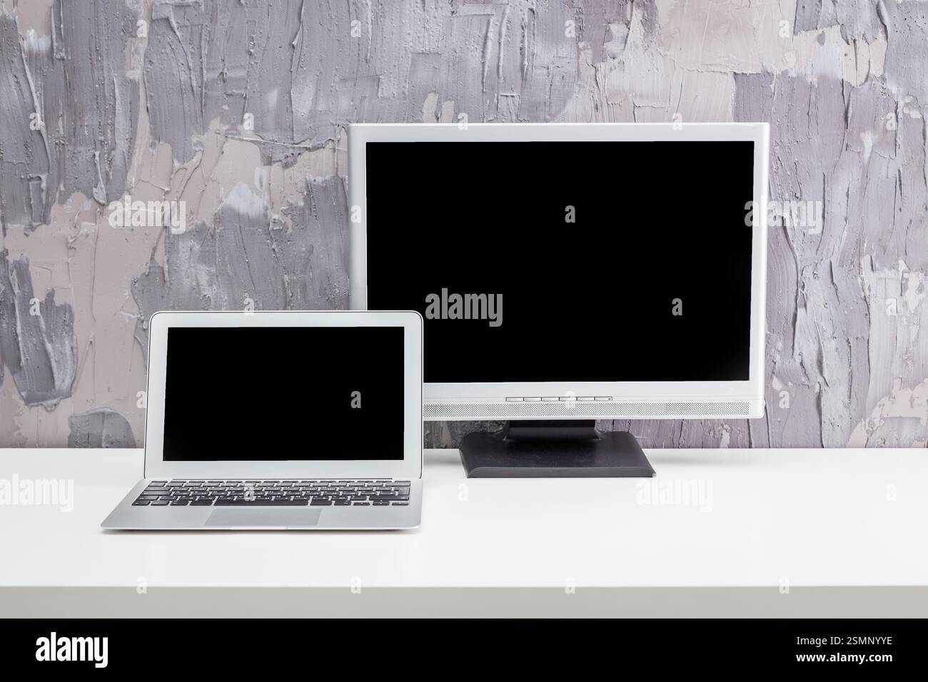 Modern workspace featuring a laptop and a computer monitor on a ...