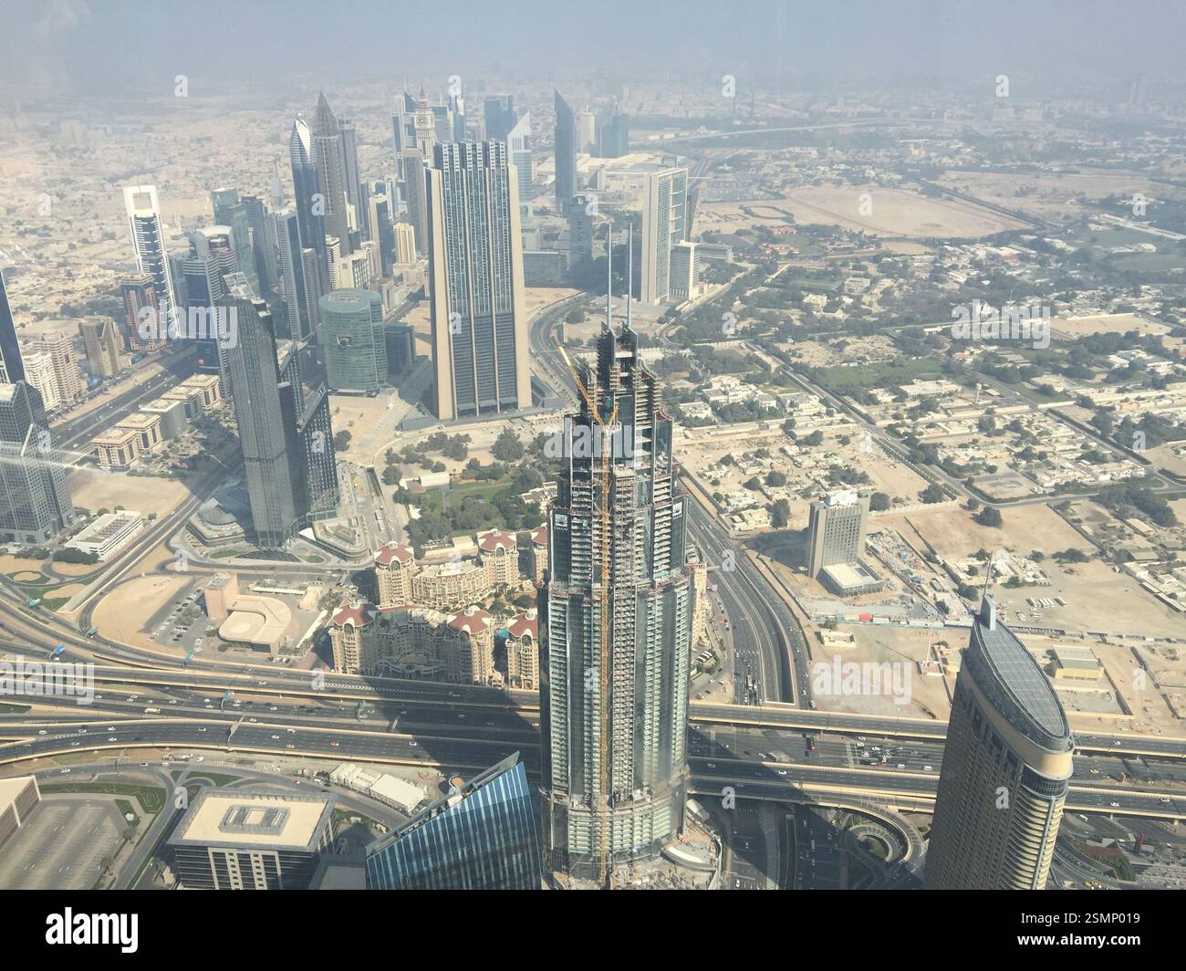 Dubai skyline under construction. Hazy day with distant desert. A ...