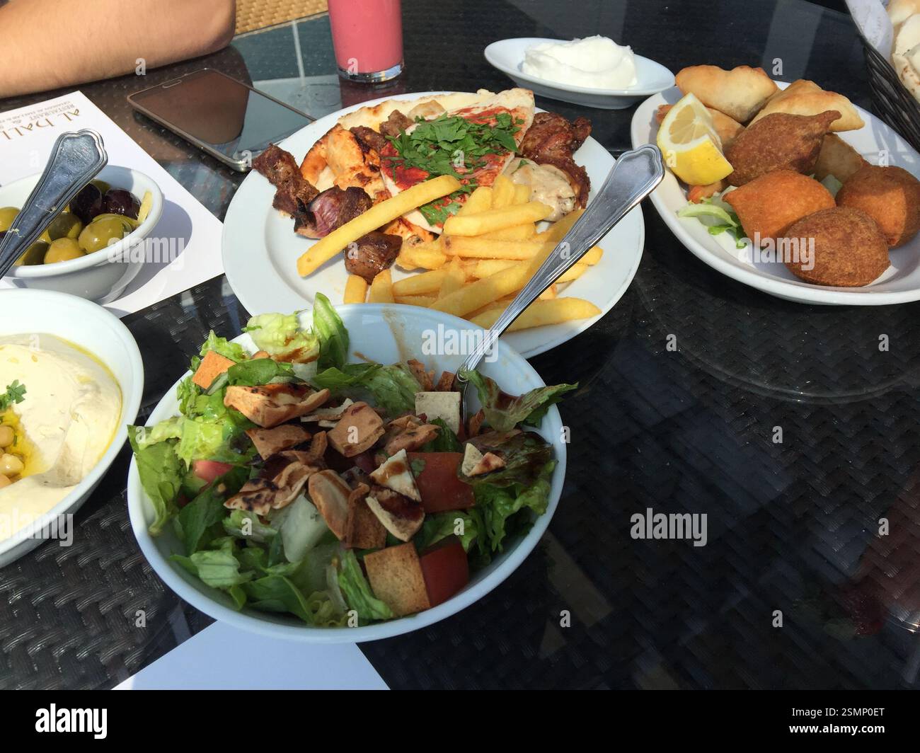 A lavish Middle Eastern feast graces a Dubai table. Hummus, crisp ...