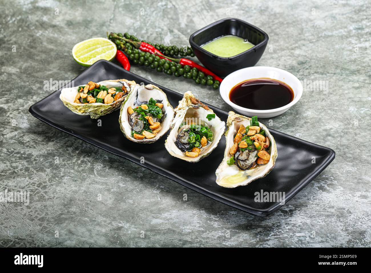 Open half oysters with green onion and peanut Stock Photo - Alamy