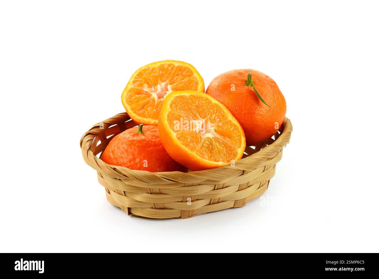 Ripe mandarin fruits and half sliced mandarin in a basket isolated on ...