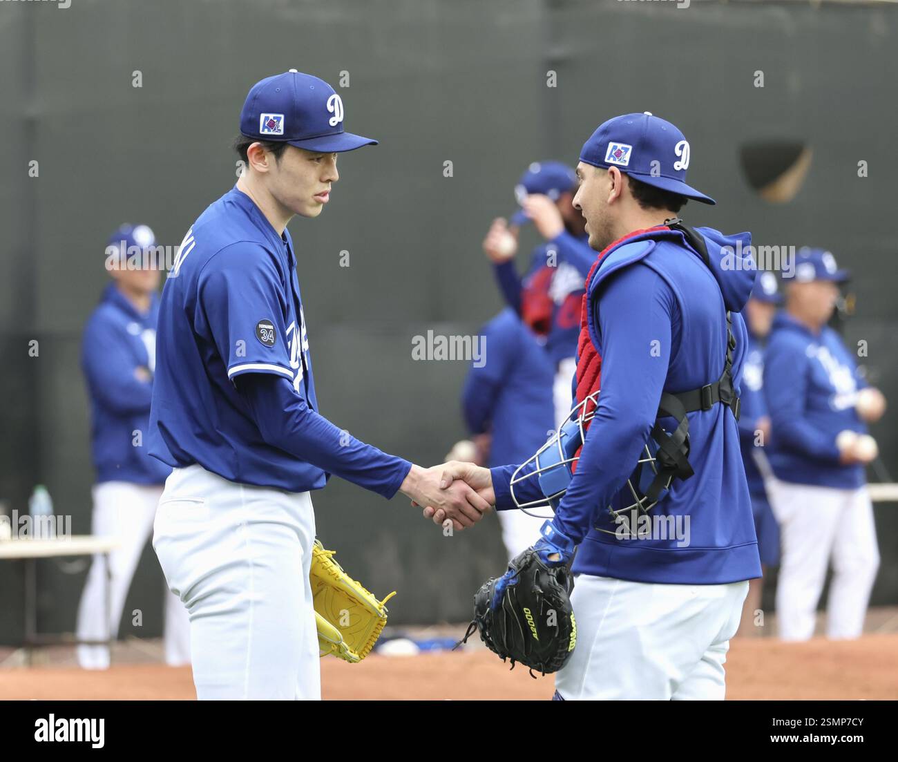 Los Angeles Dodgers rookie pitcher Roki Sasaki (L) shakes hands with ...