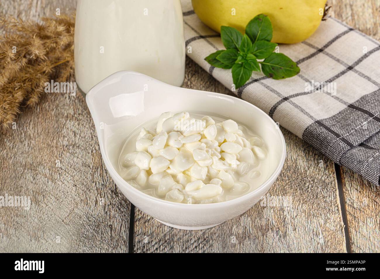 Grain cottage cheese with sour in the bowl Stock Photo - Alamy