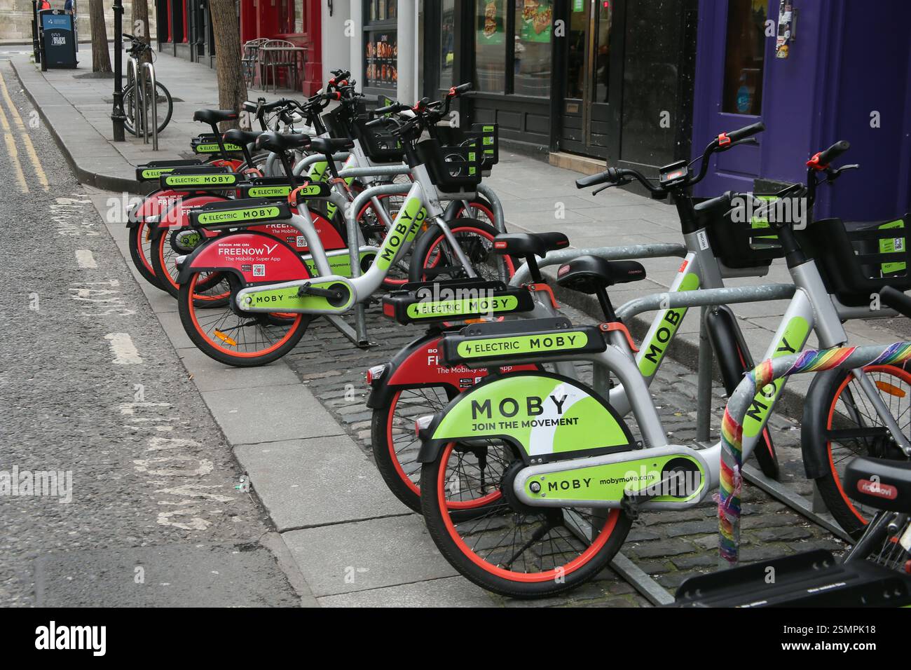 Dublin, Ireland - 12th February 2025 - Seven Moby electric bikes parked at a bicycle station on ...