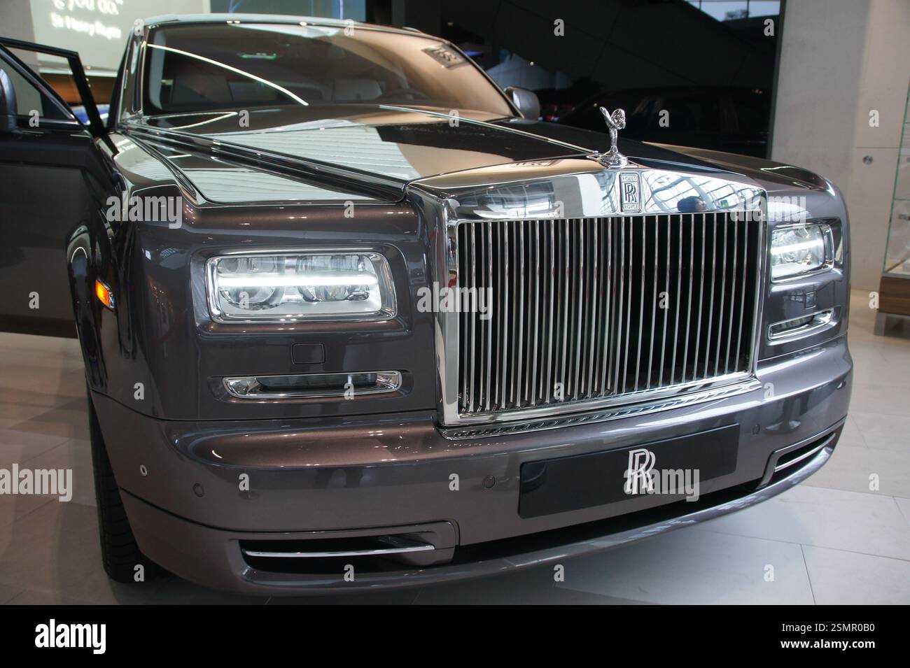 A gleaming classic car sits proudly in a showroom, its chrome grille ...