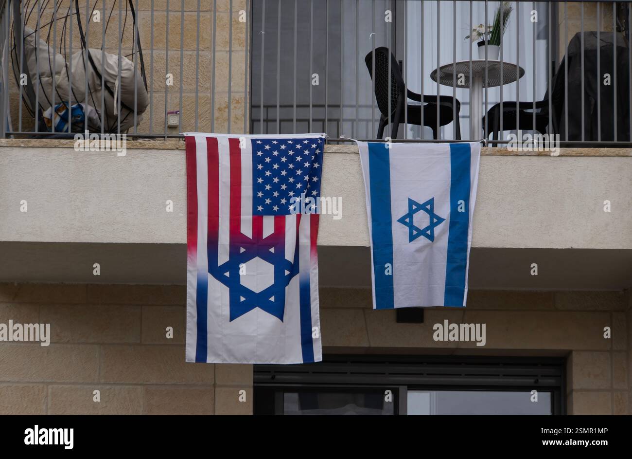 A blended Israeli and American flag hangs in a balcony of a residential ...