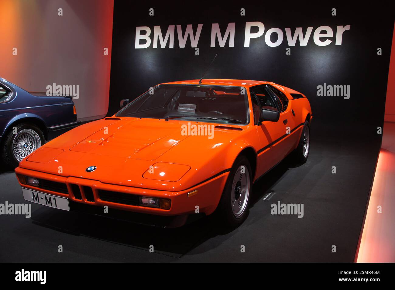 Germany, Munich. A classic orange BMW M1 car is on display at a museum ...