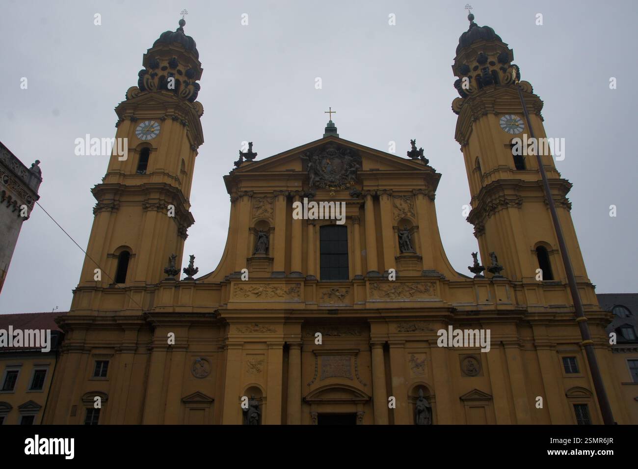 Theatine Church, a Baroque church with a red facade and two copper ...