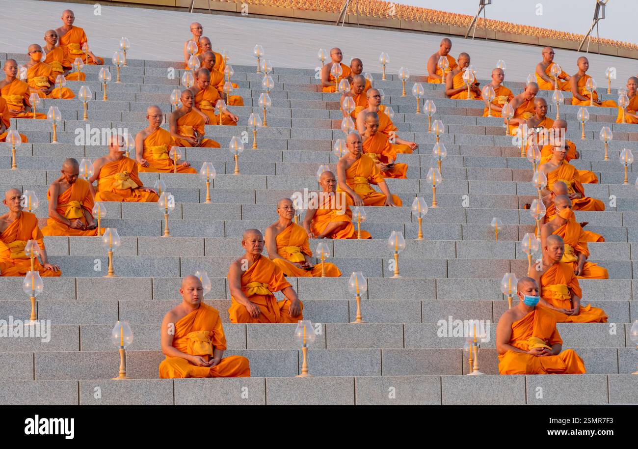 Monks sit on the temple dome during Makha Bucha Day ceremonies at Wat ...