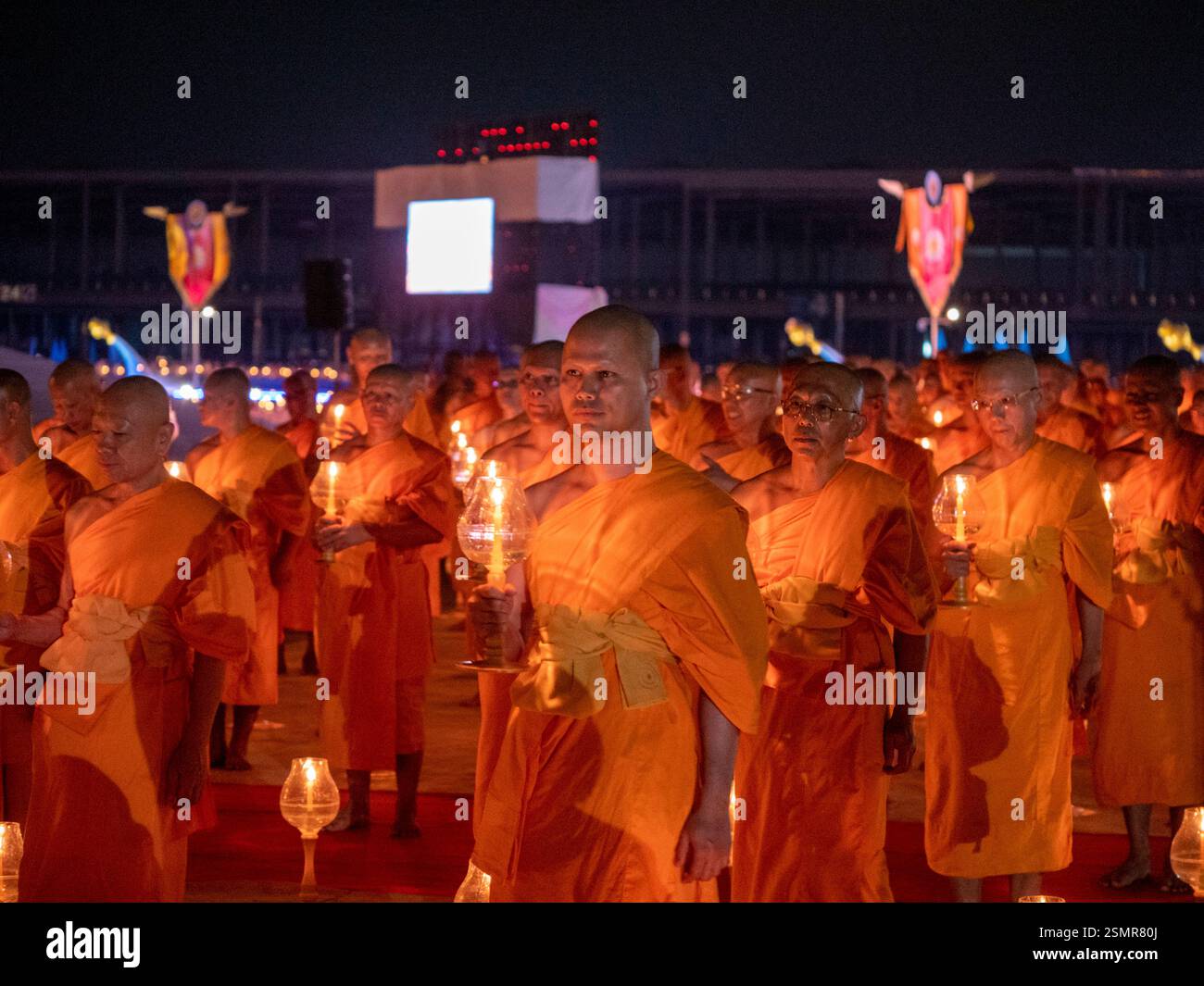 Monks walk around the temple during Makha Bucha Day ceremonies at Wat ...