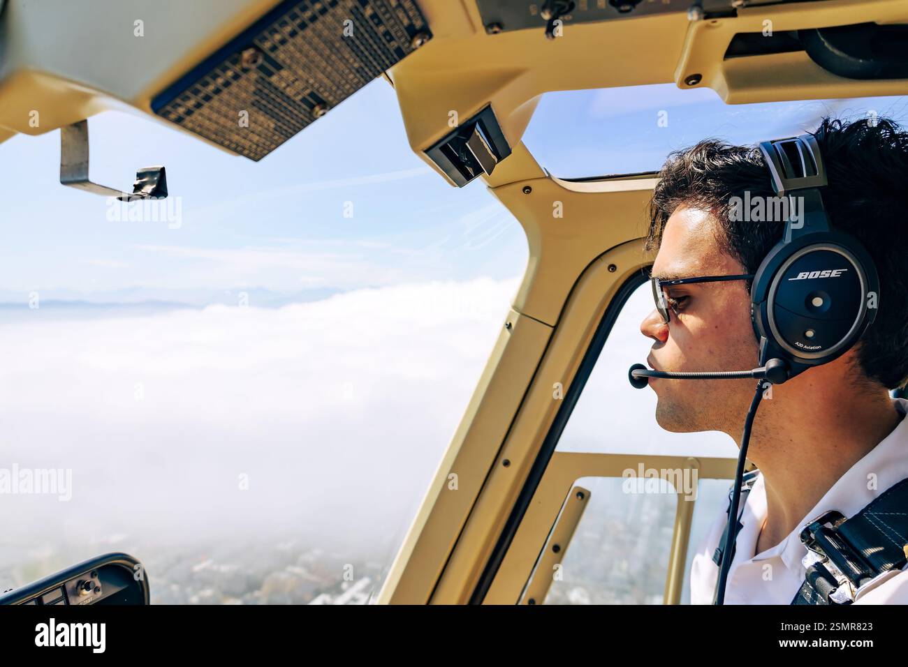 Pilot controls helicopter flying above clouds, view from inside ...