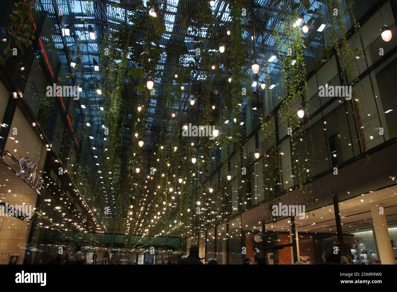 In Germany, Munich, a shopping mall features lush green plants ...