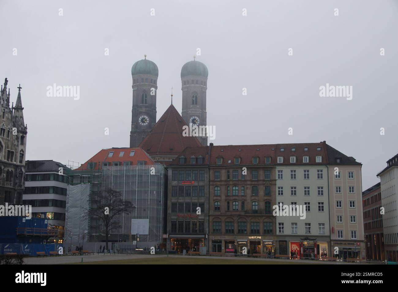 In Munich, Germany, two tall buildings with clocks face each other ...