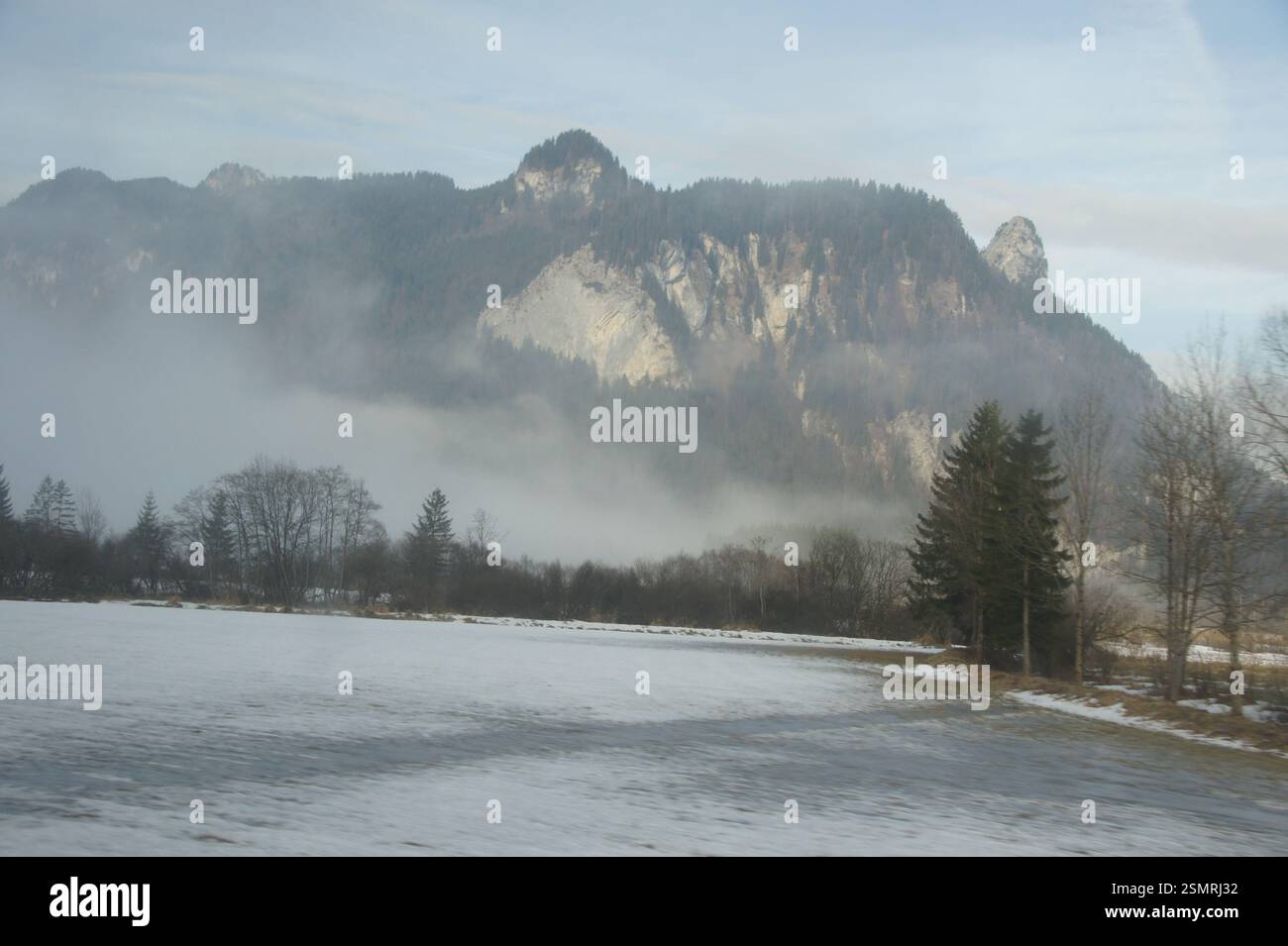 Germany, Munich. A majestic mountain rises in the distance behind a ...