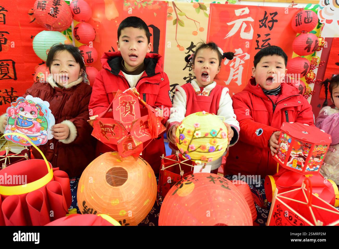 Children learn to make lanterns to welcome the Lantern Festival in ...