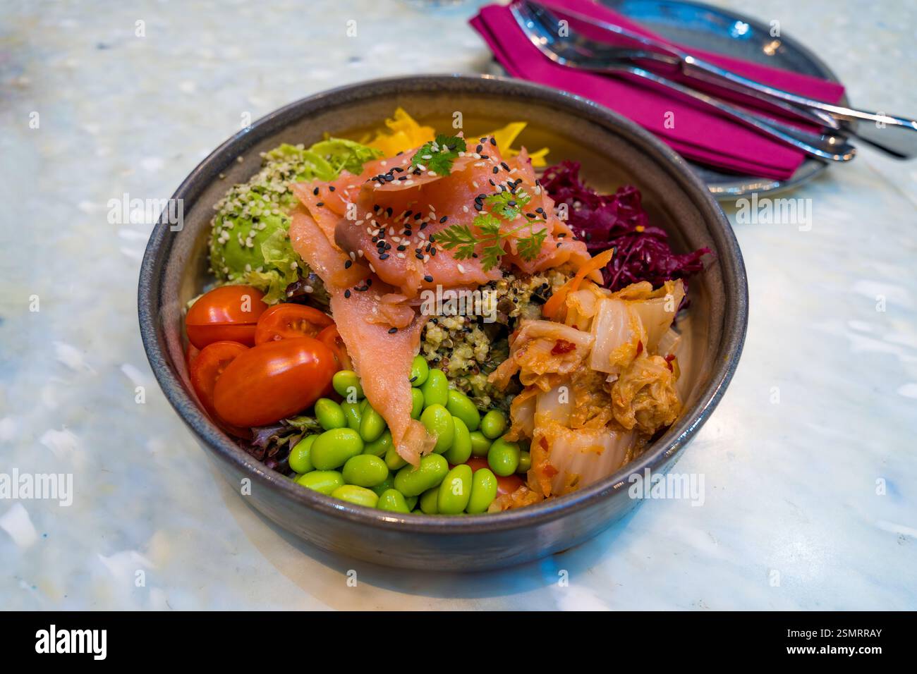 Healthy poke bowl with smoked salmon, quinoa, and fresh vegetables ...