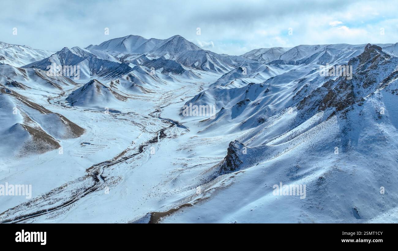 Aerial photo shows the snow-covered mountains in Jiuquan City,northwest ...