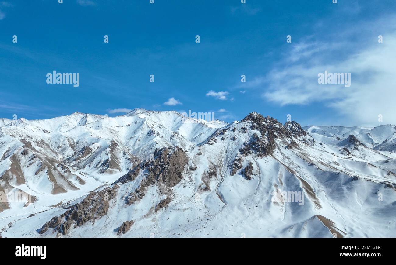 Aerial photo shows the snow-covered mountains in Jiuquan City,northwest ...