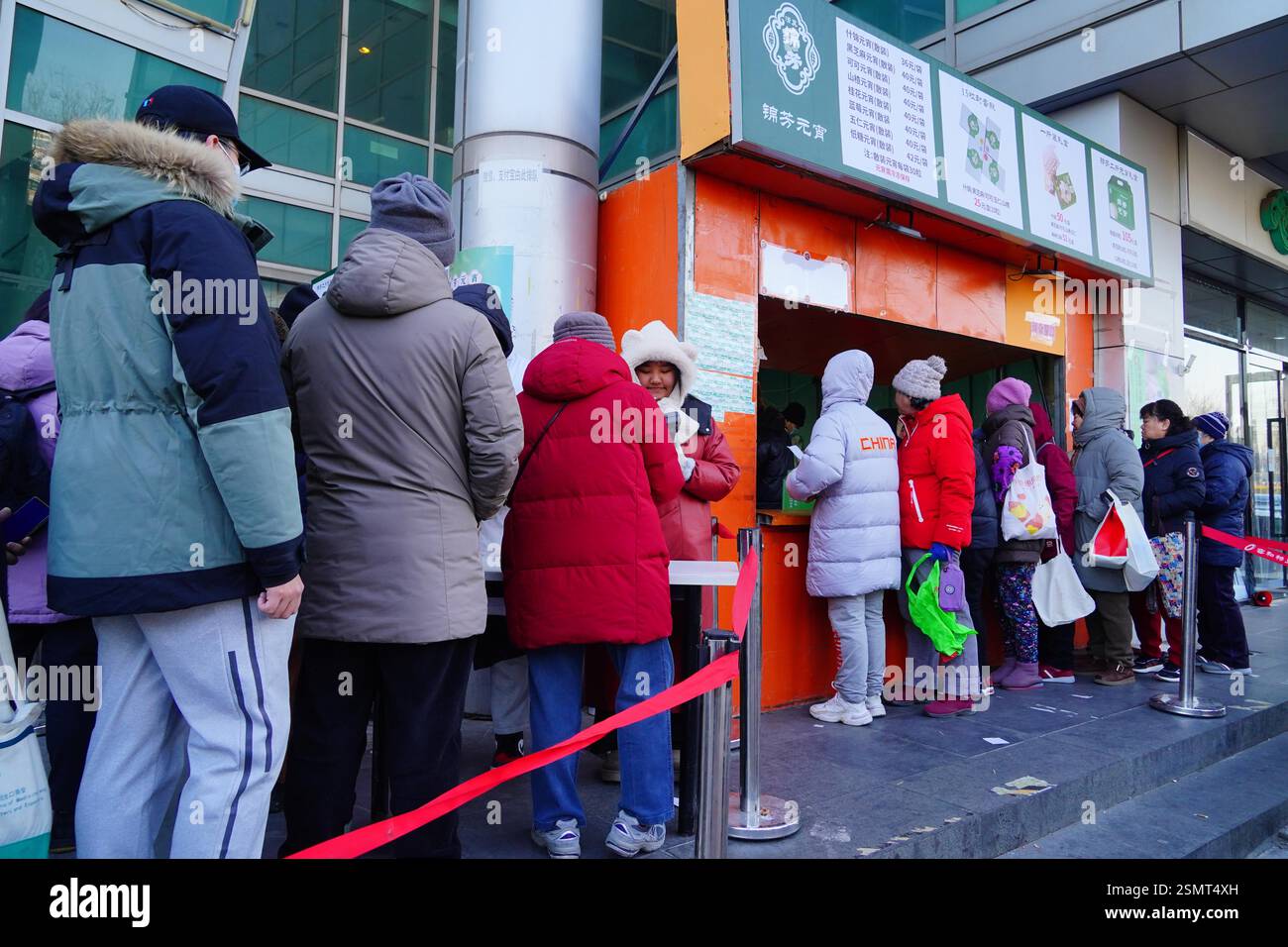 People line up to buy glutinous rice balls known as yuanxiao in Beijing ...