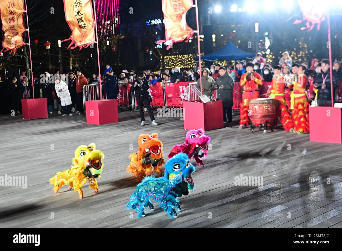 Robot dogs, with lion head-shaped decorations, perform dance alongside ...