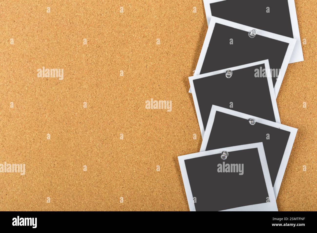 Collection of empty photo frames pinned on a corkboard ready for ...