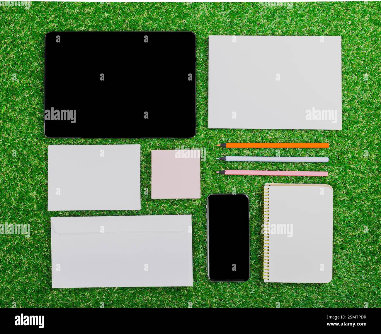 Organized workspace featuring digital devices, stationery, and ...