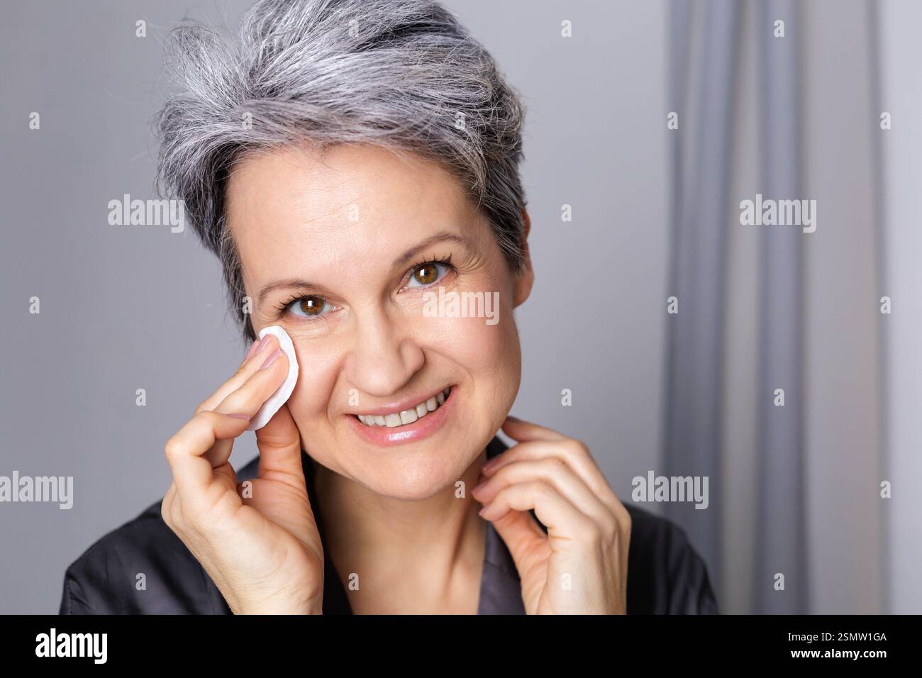 Mature well-groomed beautiful woman during menopause with grey hair ...